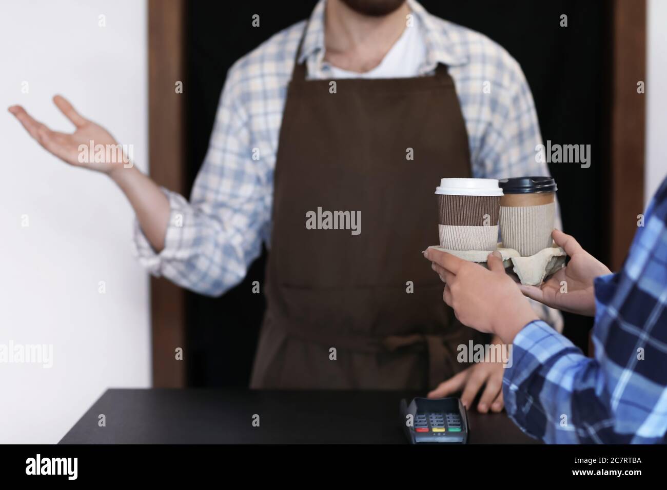 Male barista and client in modern cafe Stock Photo - Alamy