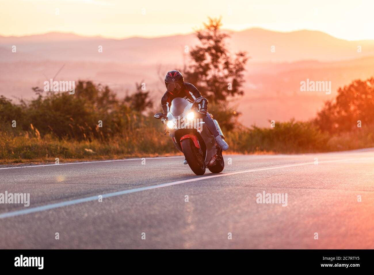 Riding a motobike during sunset Stock Photo - Alamy