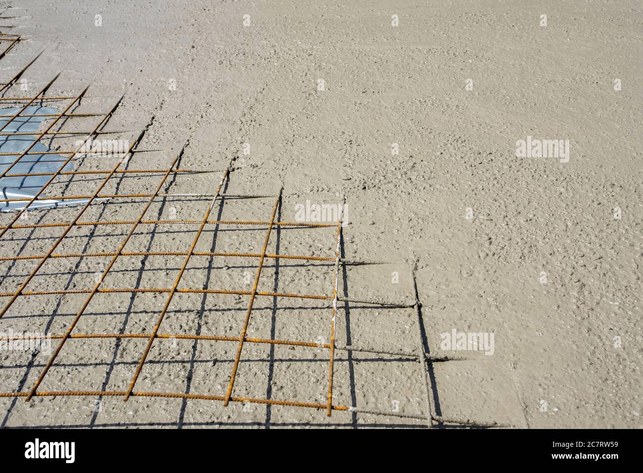 High angle shot of fresh poured concrete with steel reinforcement Stock ...