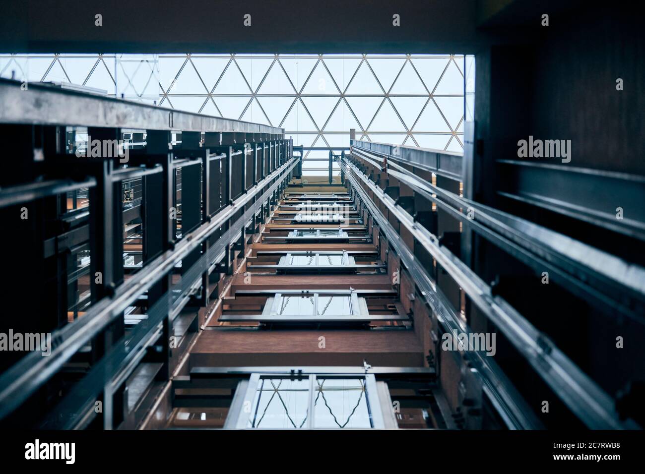 Open elevator lift shaft. Modern architecture with transparent ceiling ...