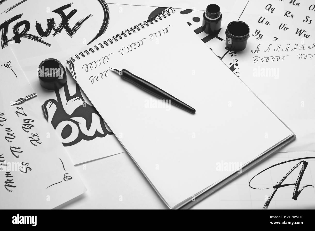 Composition with notebook, nib pen and ink Stock Photo - Alamy