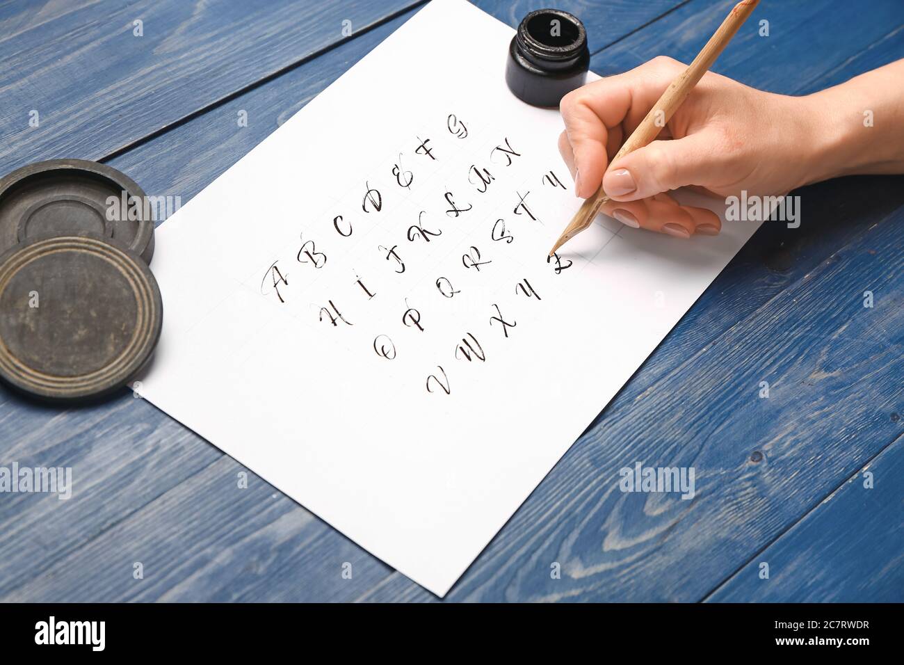 Woman practicing calligraphy table hi-res stock photography and images ...