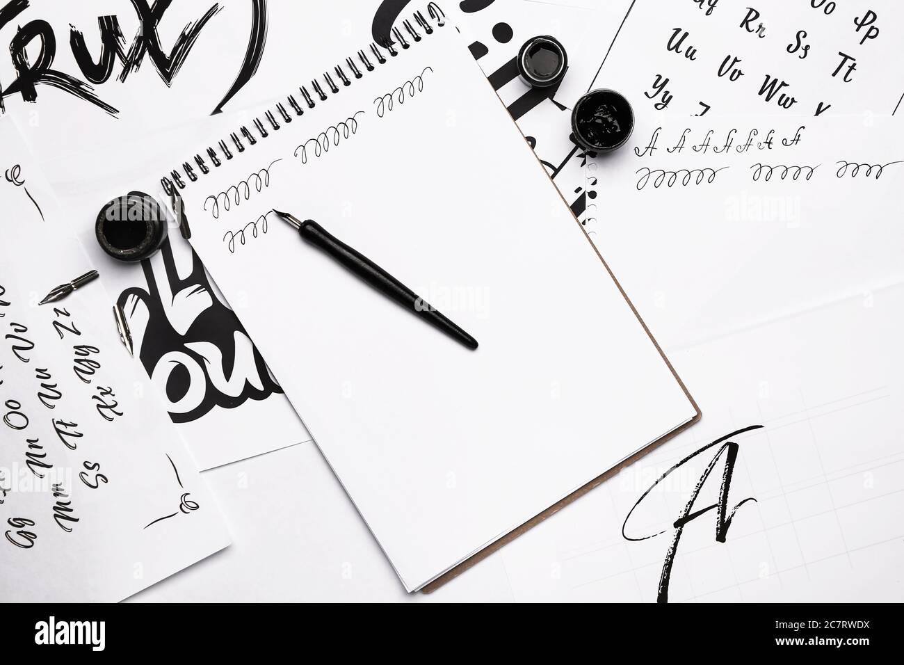 Composition with notebook, nib pen and ink Stock Photo - Alamy
