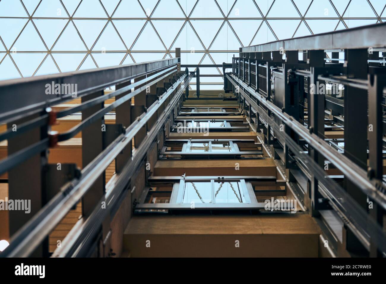 Open elevator lift shaft. Modern architecture with transparent ceiling ...