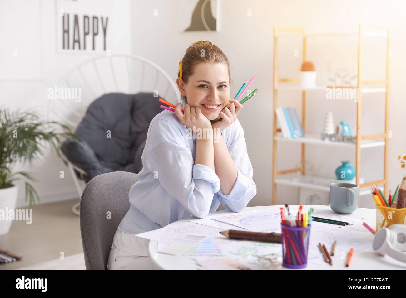 Young woman coloring picture at home Stock Photo - Alamy