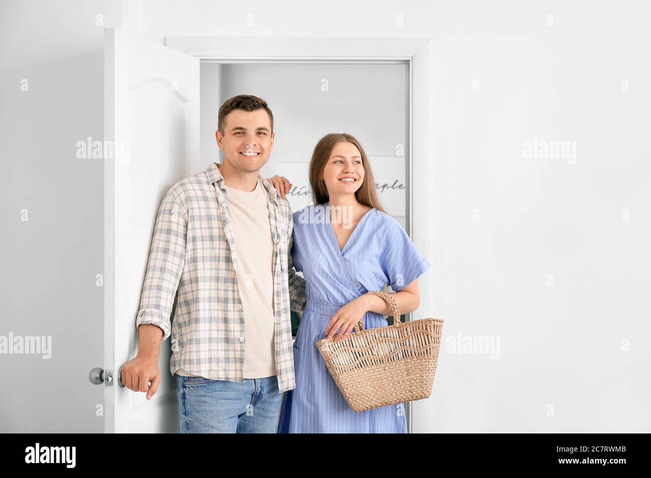 Happy couple opening door at their new home Stock Photo - Alamy