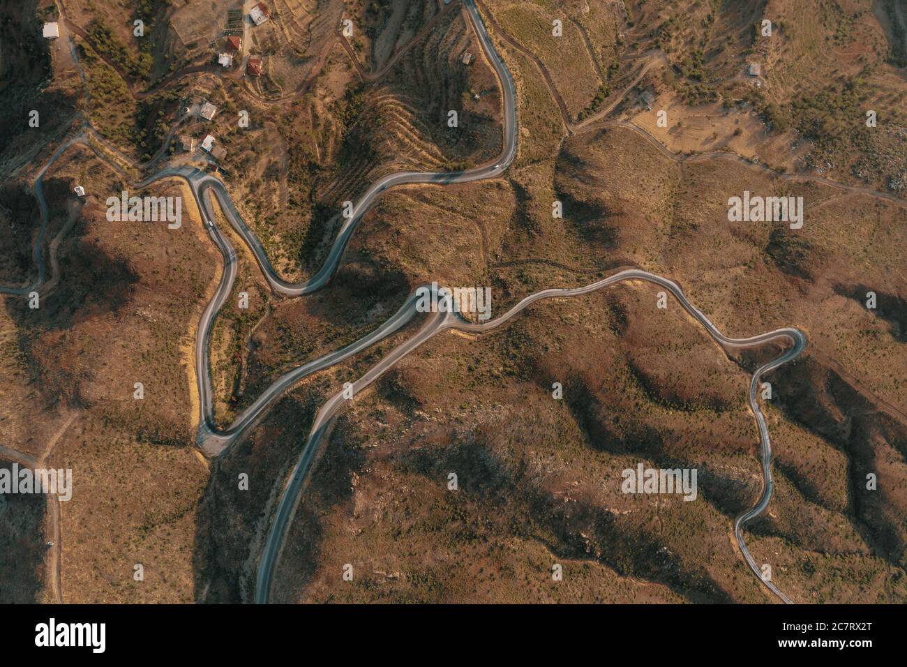 Aerial view of a path leading to an impressive mountain landscape in ...