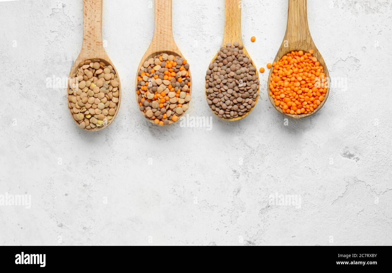 Spoons with lentils on white background Stock Photo - Alamy