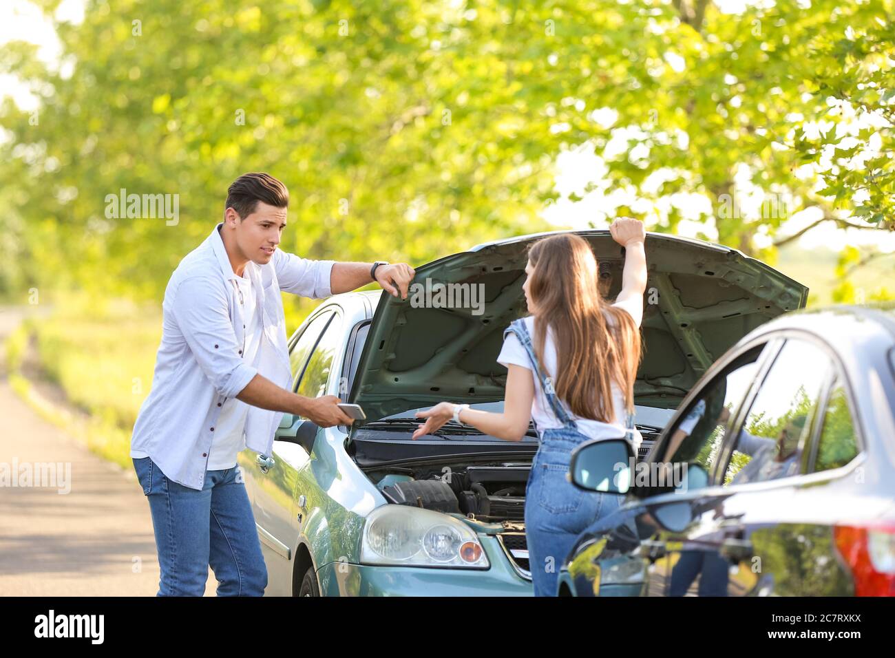 Stressed drivers near broken cars after accident Stock Photo - Alamy