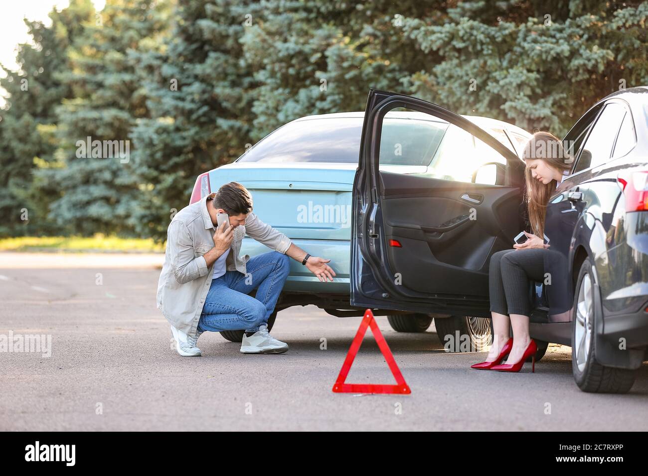 Stressed drivers after car accident on road Stock Photo - Alamy
