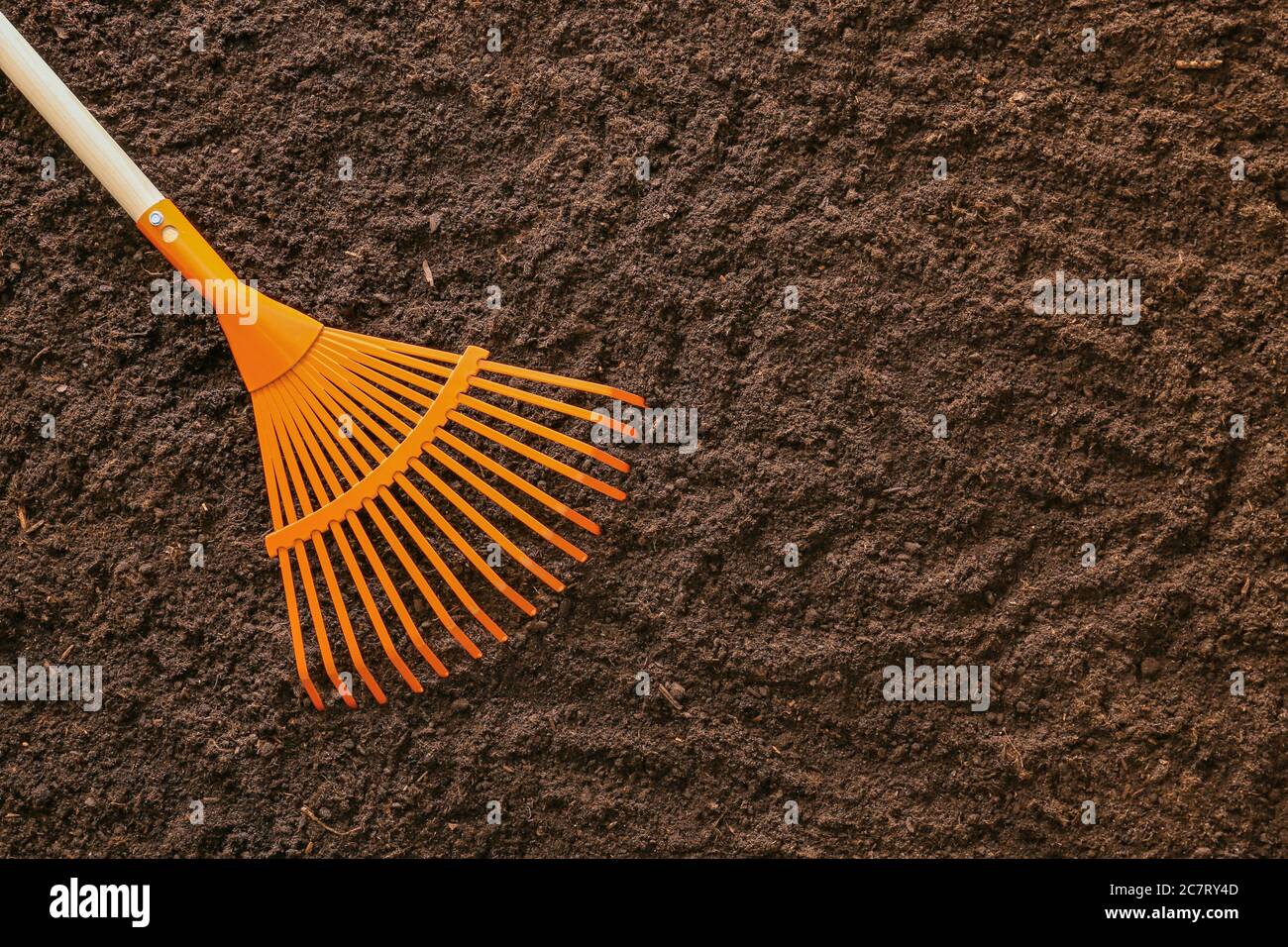 Rake for gardening on soil background Stock Photo - Alamy