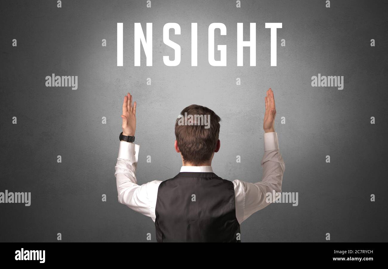 Rear view of a businessman with INSIGHT inscription, powerfull business ...
