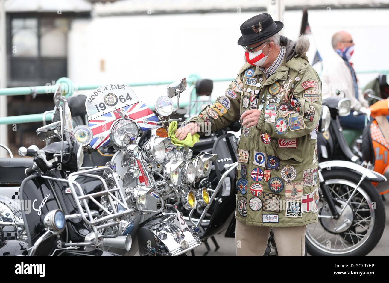 Brighton, UK. 19th July, 2020. A mod polishes his scooter as Mods and ...