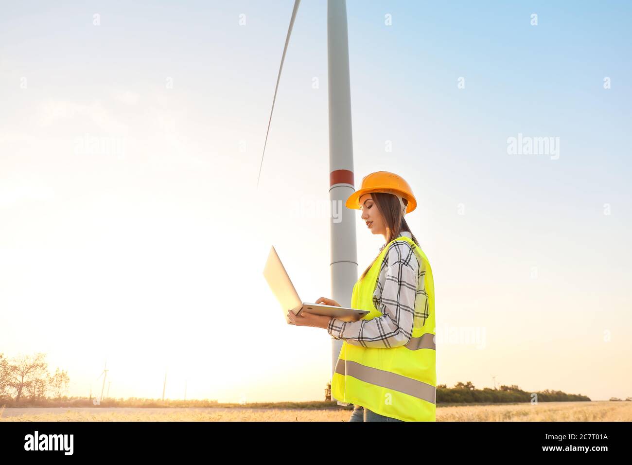 Female engineer on windmill farm for electric power production Stock ...