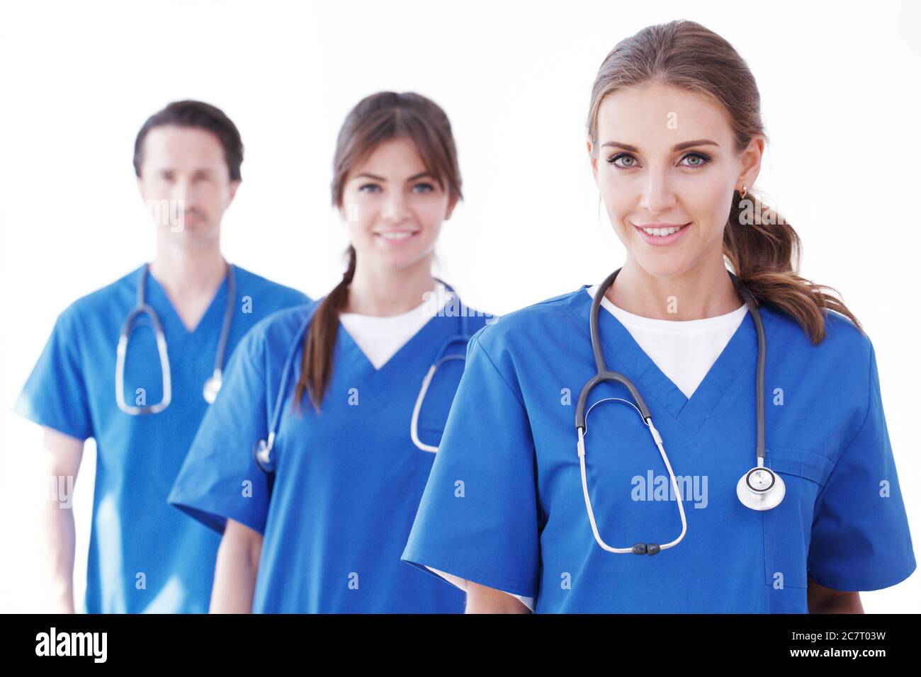 Team of professional doctors in blue uniform isolated on white ...