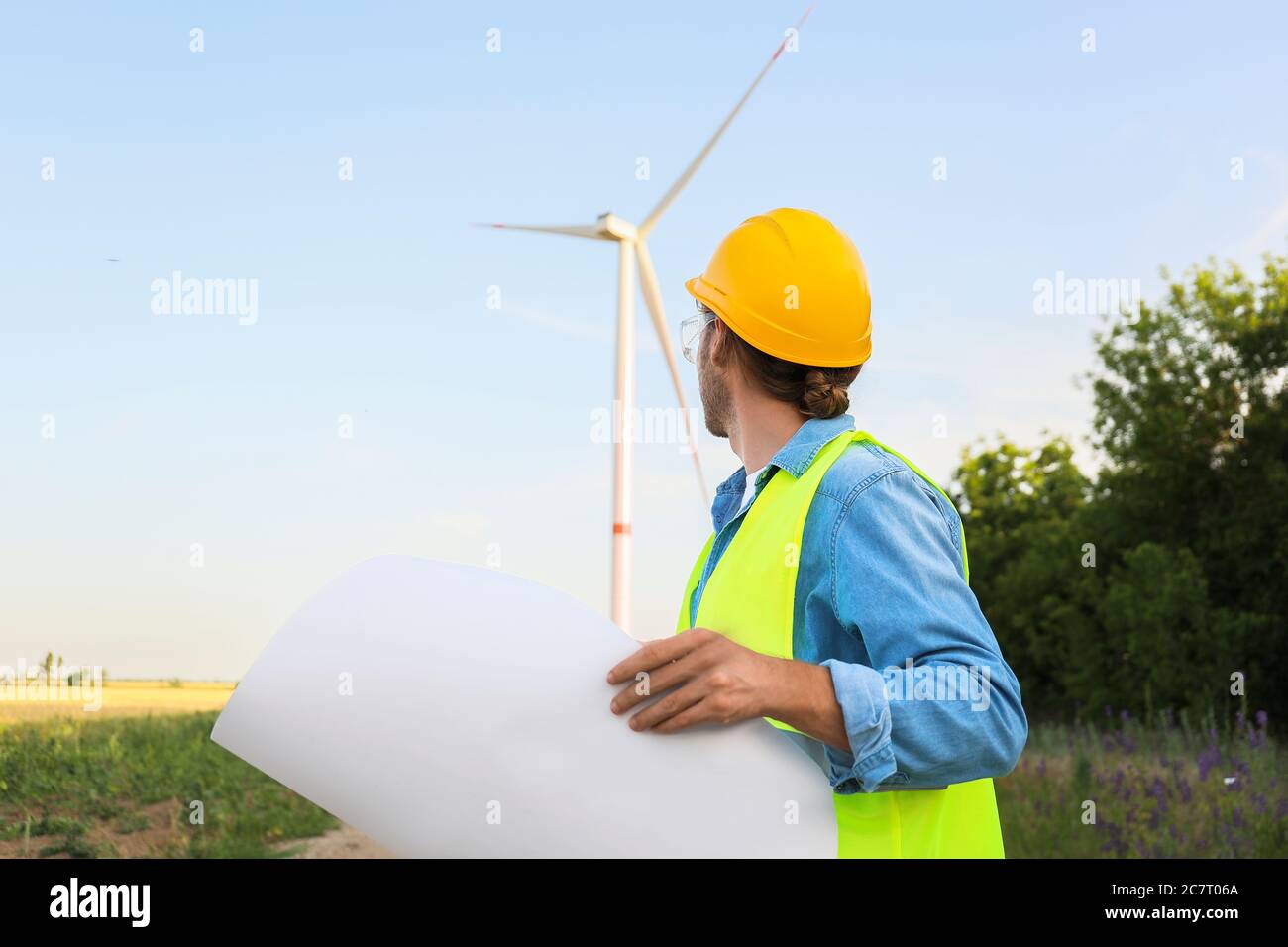 Male engineer on windmill farm for electric power production Stock ...