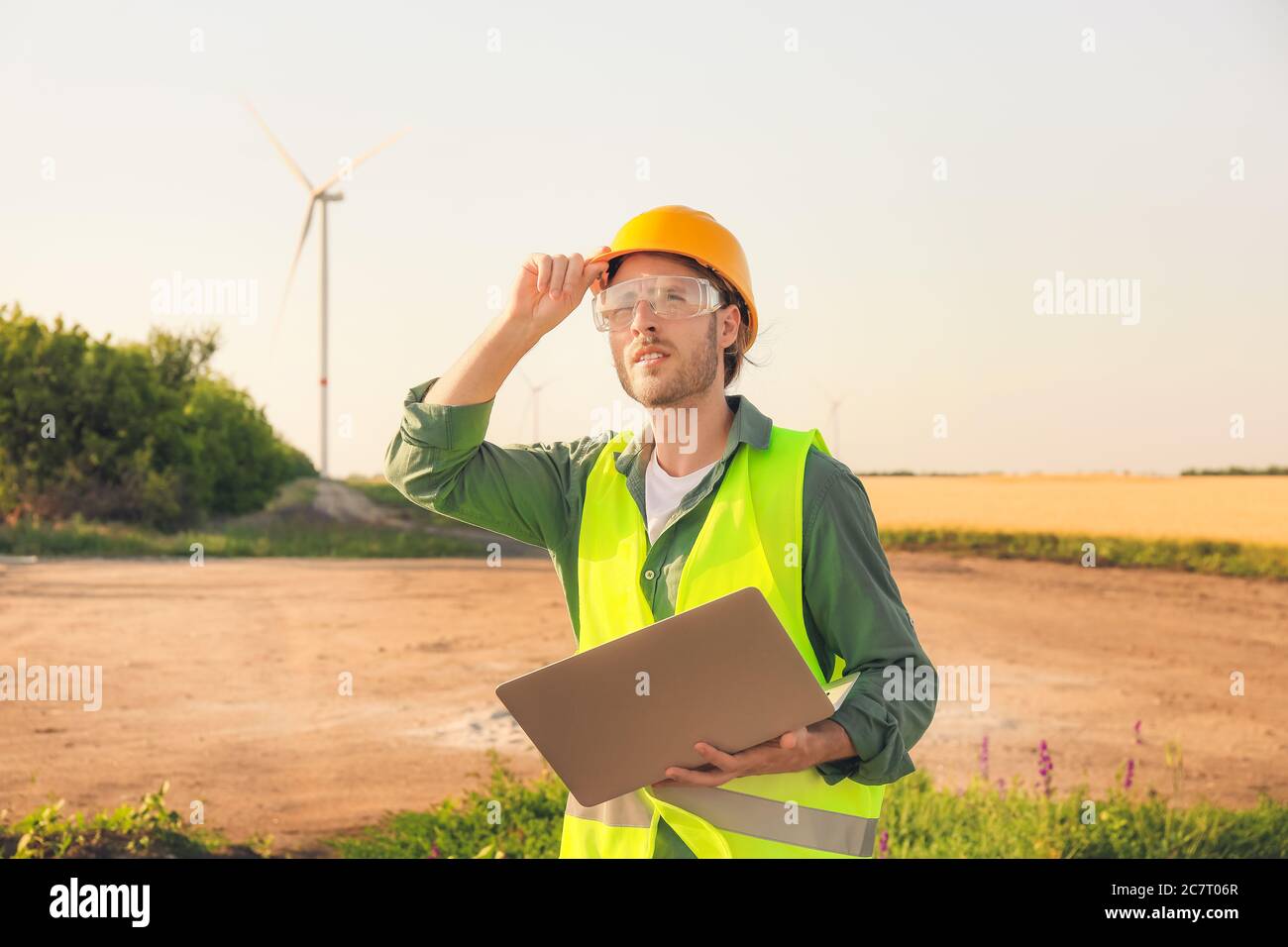 Male engineer on windmill farm for electric power production Stock ...