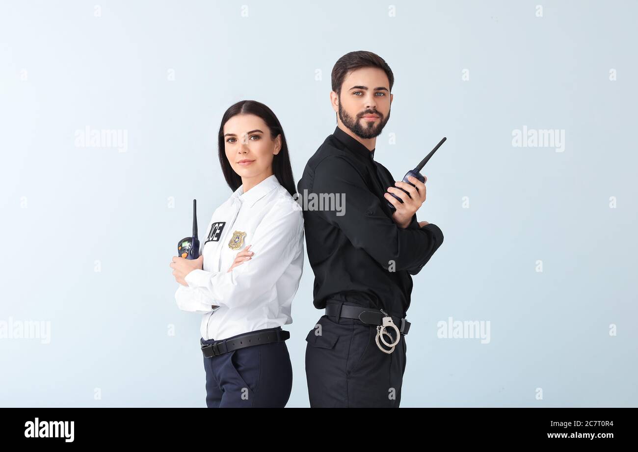 Police officers on light background Stock Photo - Alamy