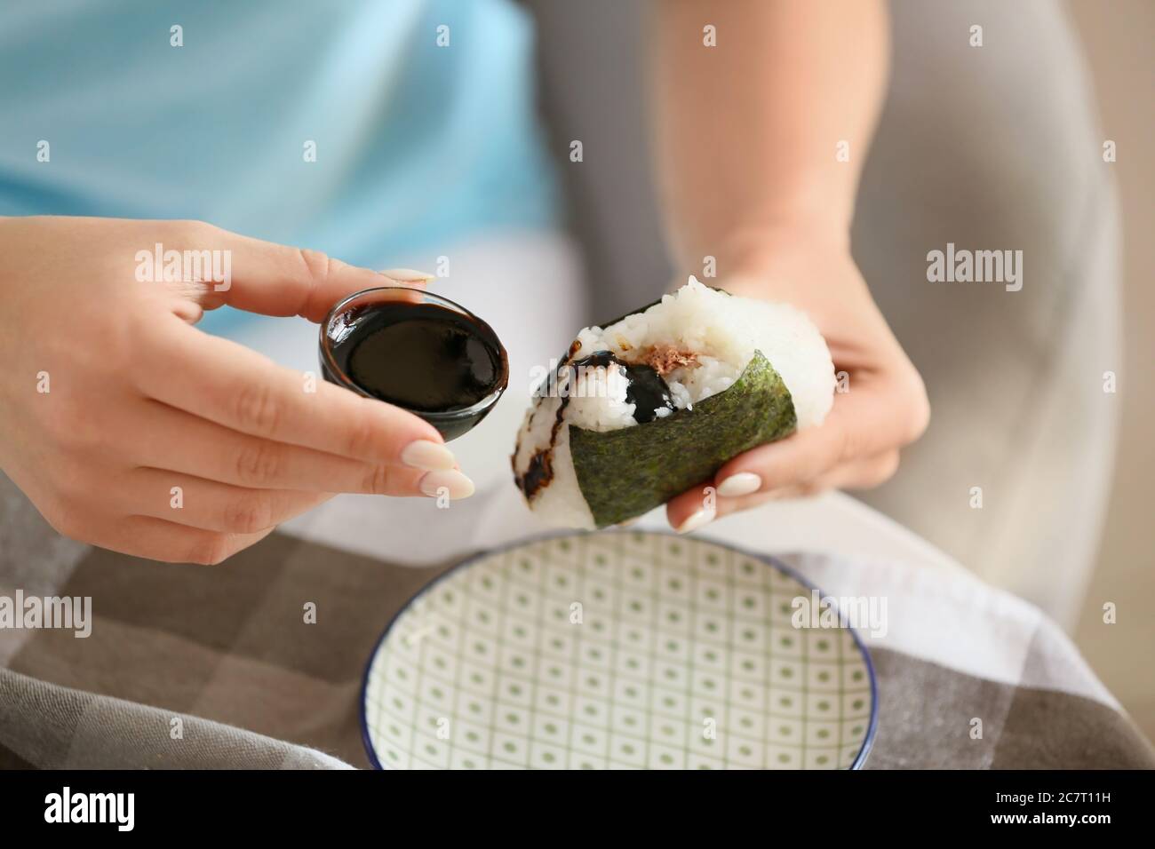 Woman eating traditional Japanese onigiri, closeup Stock Photo - Alamy