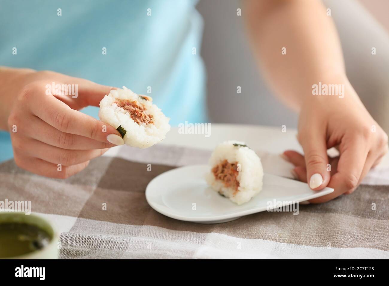 Woman eating traditional Japanese onigiri, closeup Stock Photo - Alamy