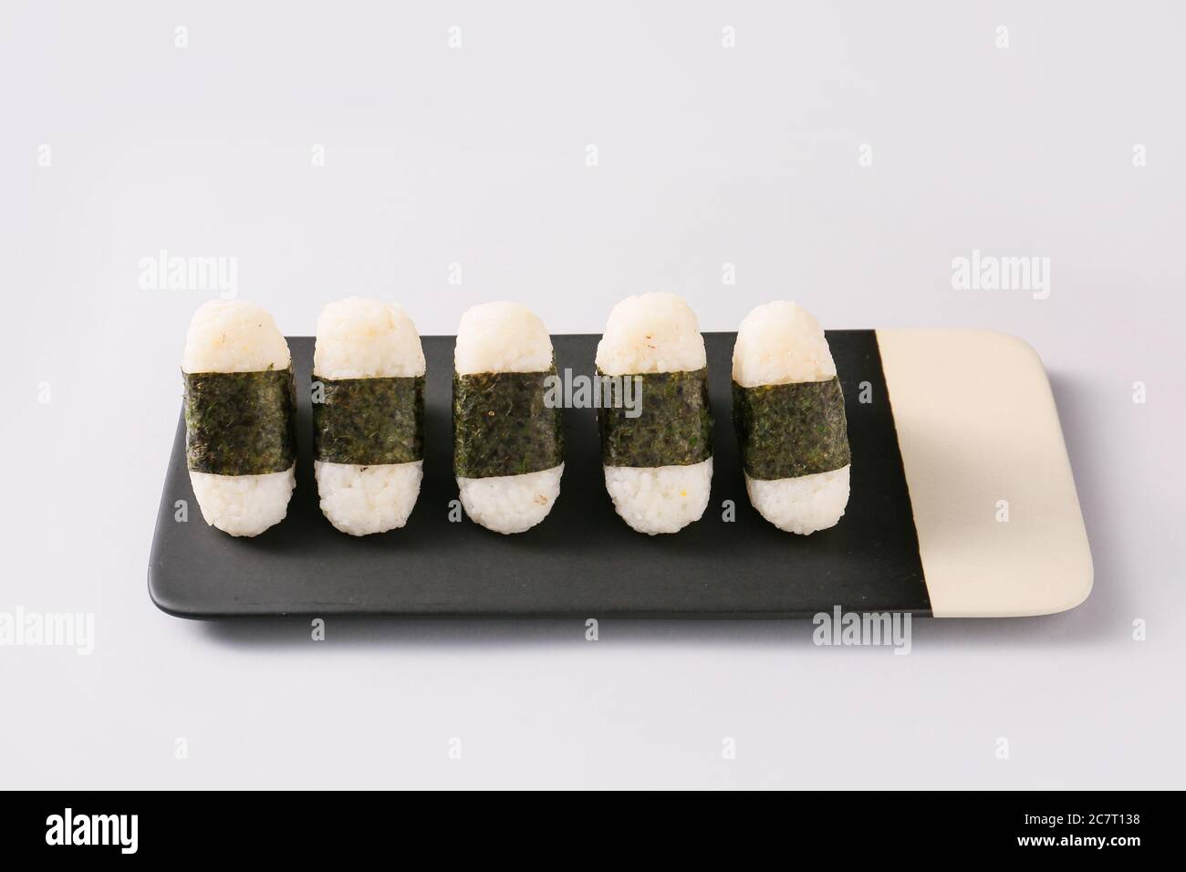 Plate with traditional Japanese onigiri on grey background Stock Photo ...
