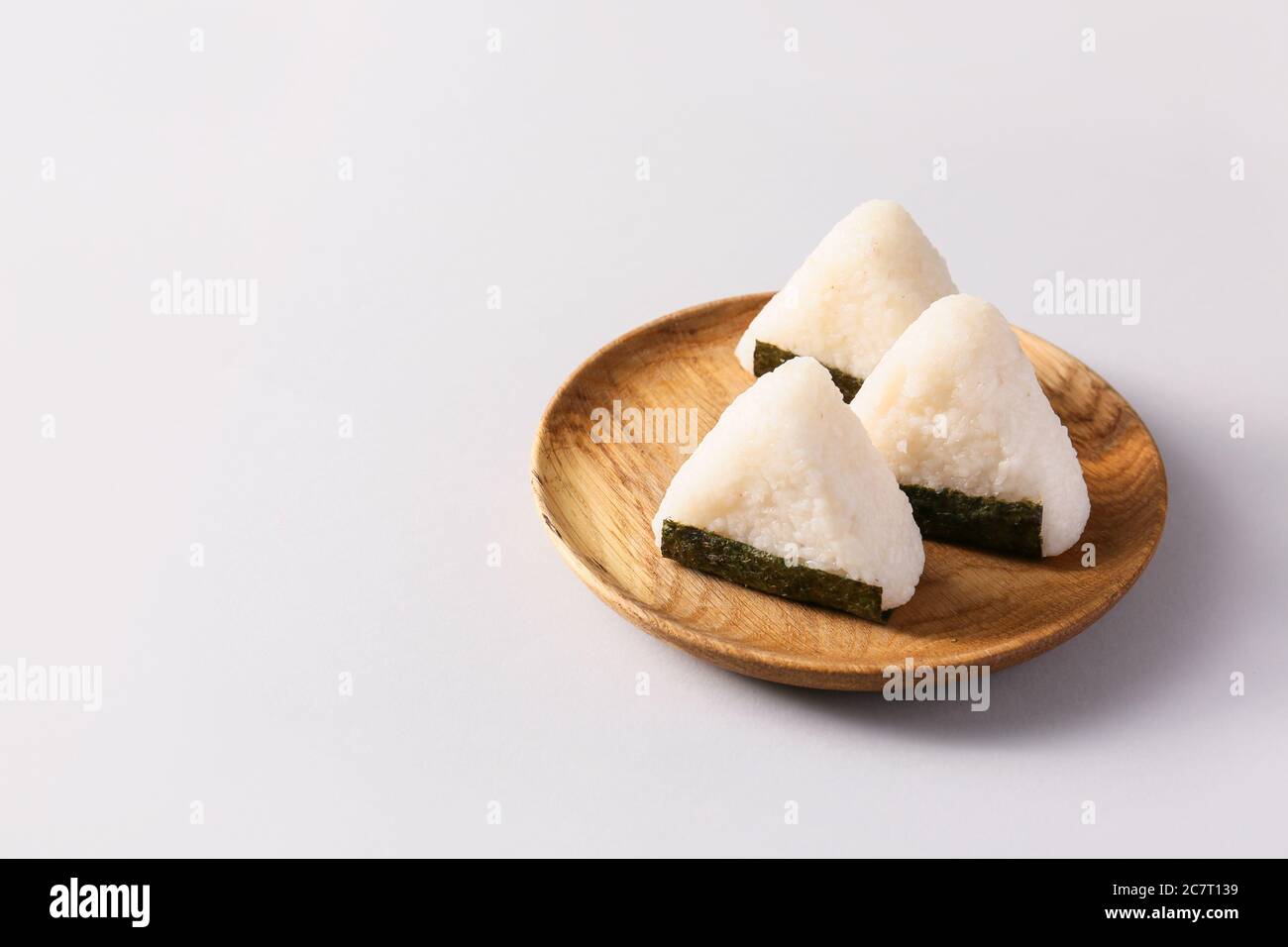 Plate with traditional Japanese onigiri on grey background Stock Photo ...