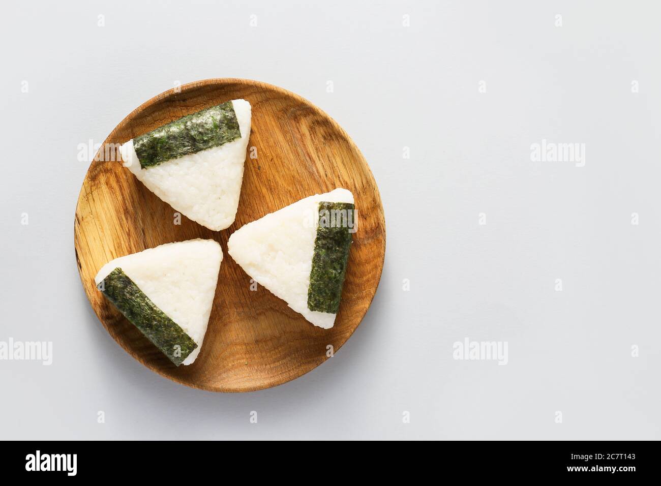 Plate with traditional Japanese onigiri on grey background Stock Photo ...