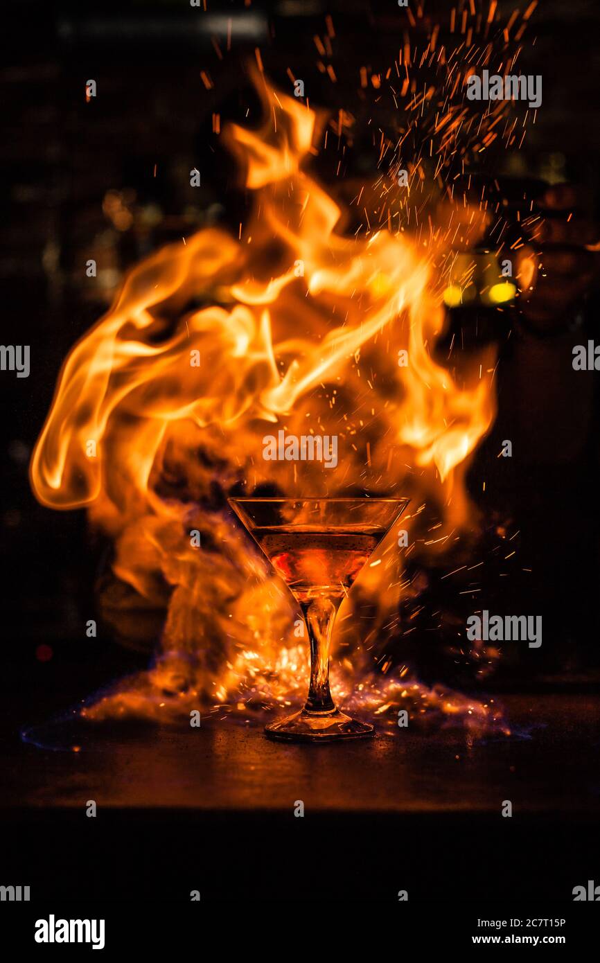 The bartender makes a cocktail of fire Stock Photo - Alamy