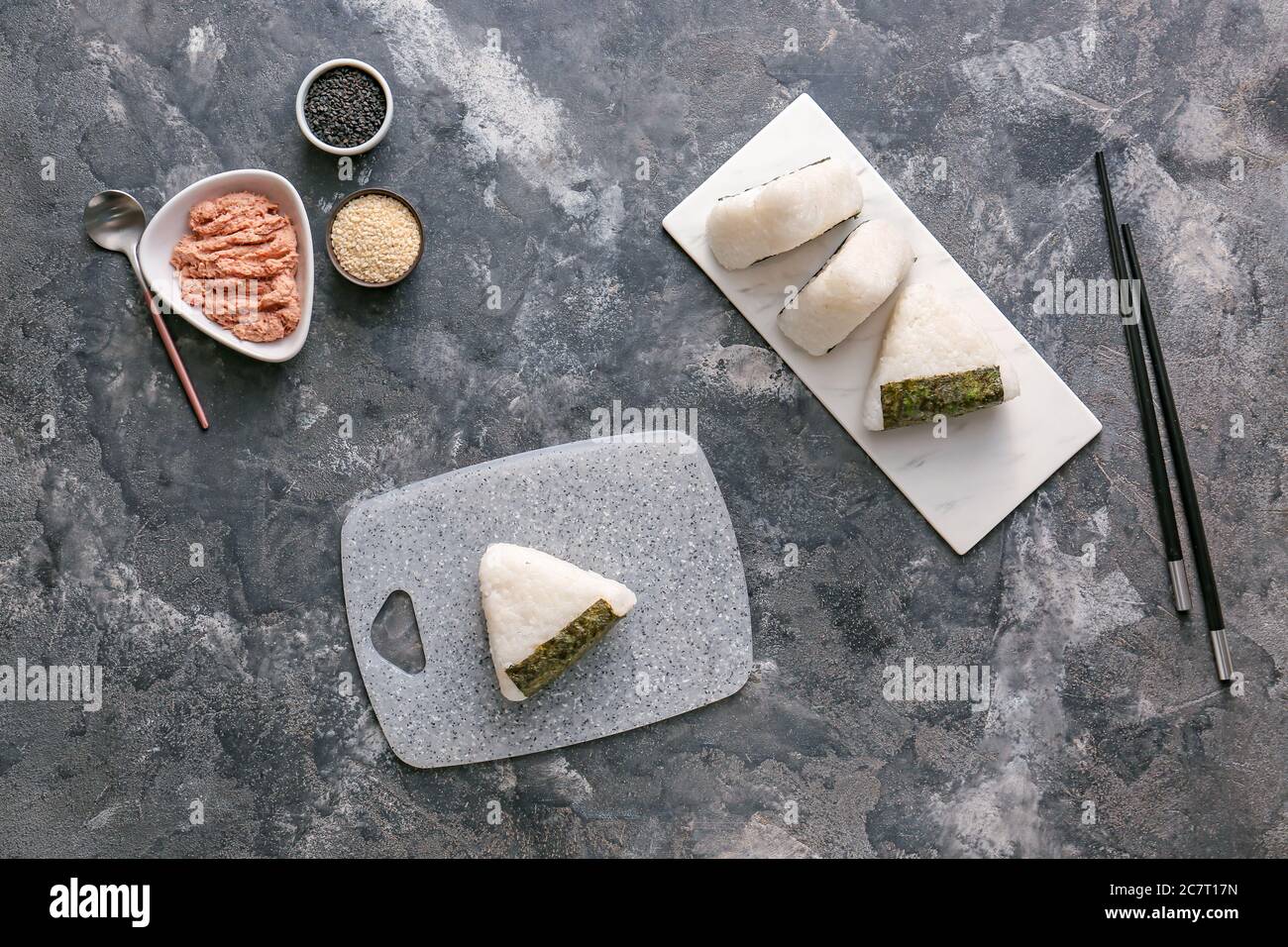 Traditional Japanese onigiri with ingredients on grey background Stock ...
