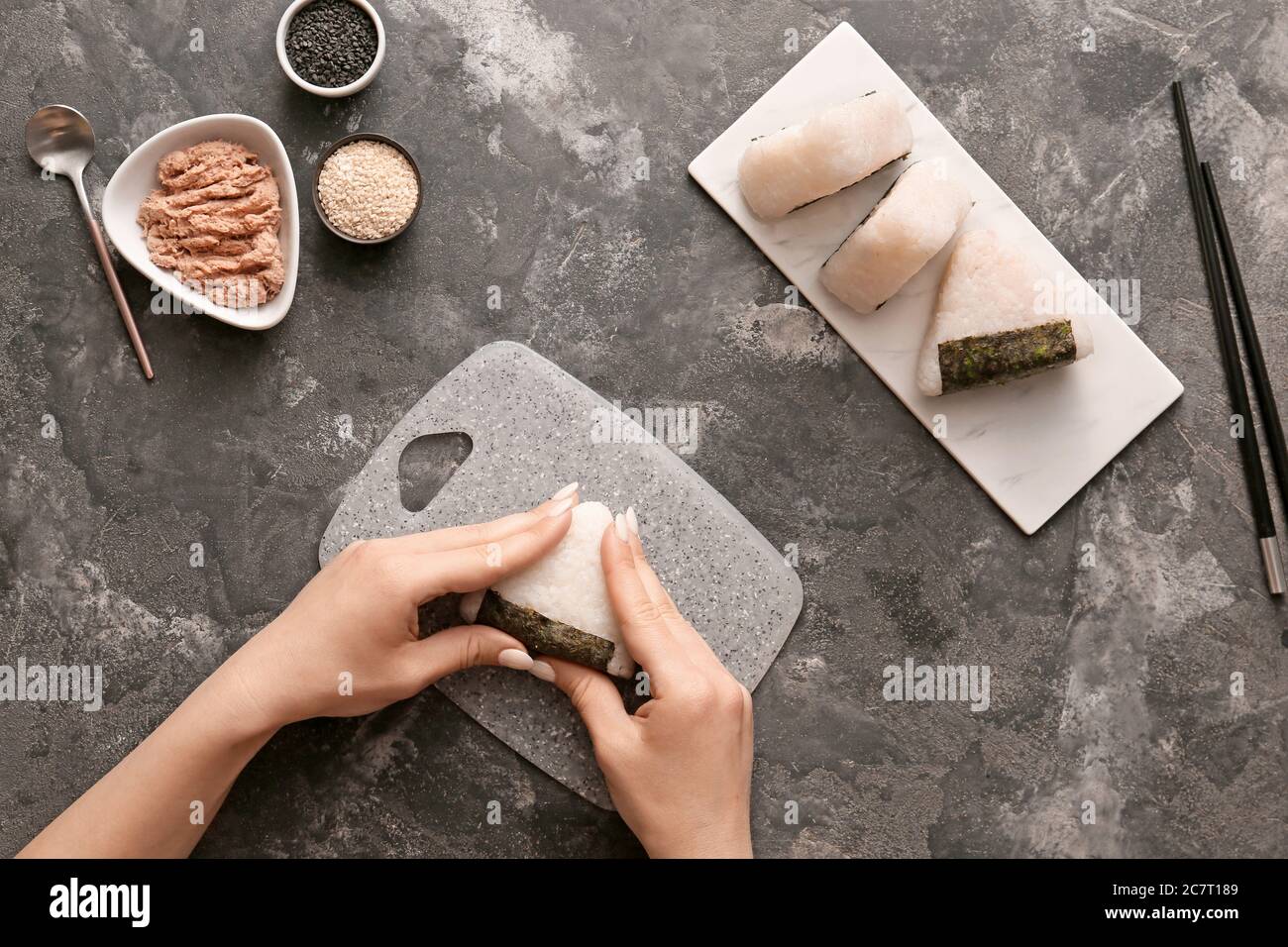 Woman preparing traditional Japanese onigiri on table Stock Photo - Alamy