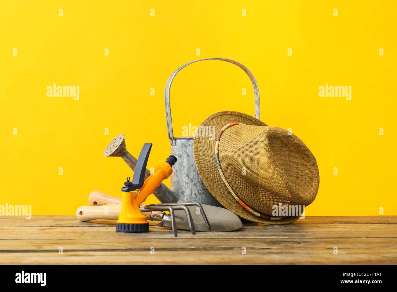 Gardening tools on table against color background Stock Photo - Alamy