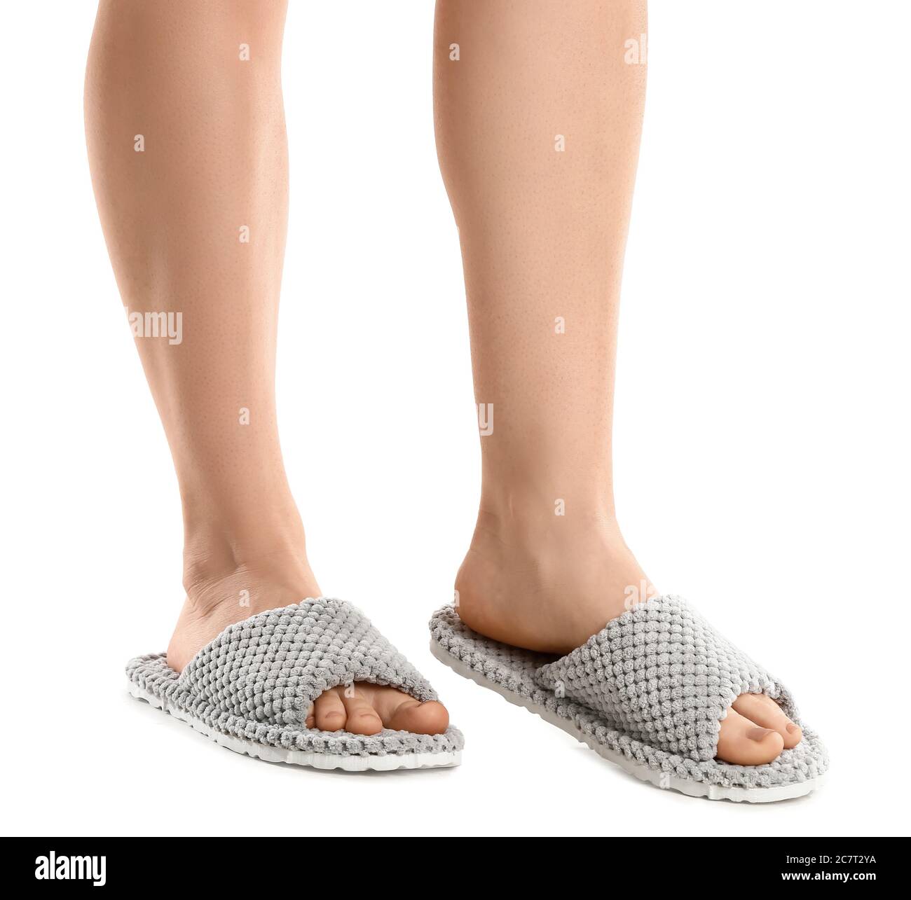Female legs in soft slippers on white background Stock Photo - Alamy
