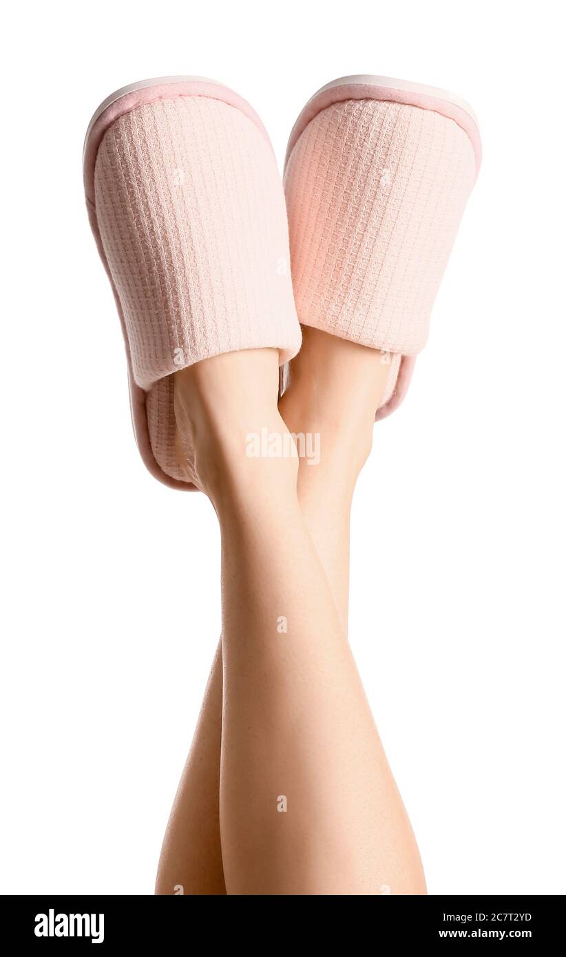 Female legs in soft slippers on white background Stock Photo - Alamy