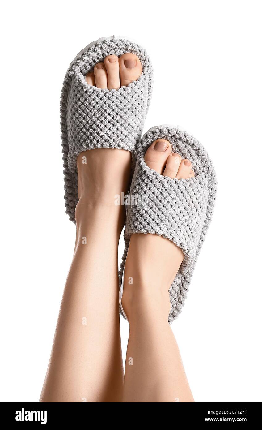 Female legs in soft slippers on white background Stock Photo - Alamy