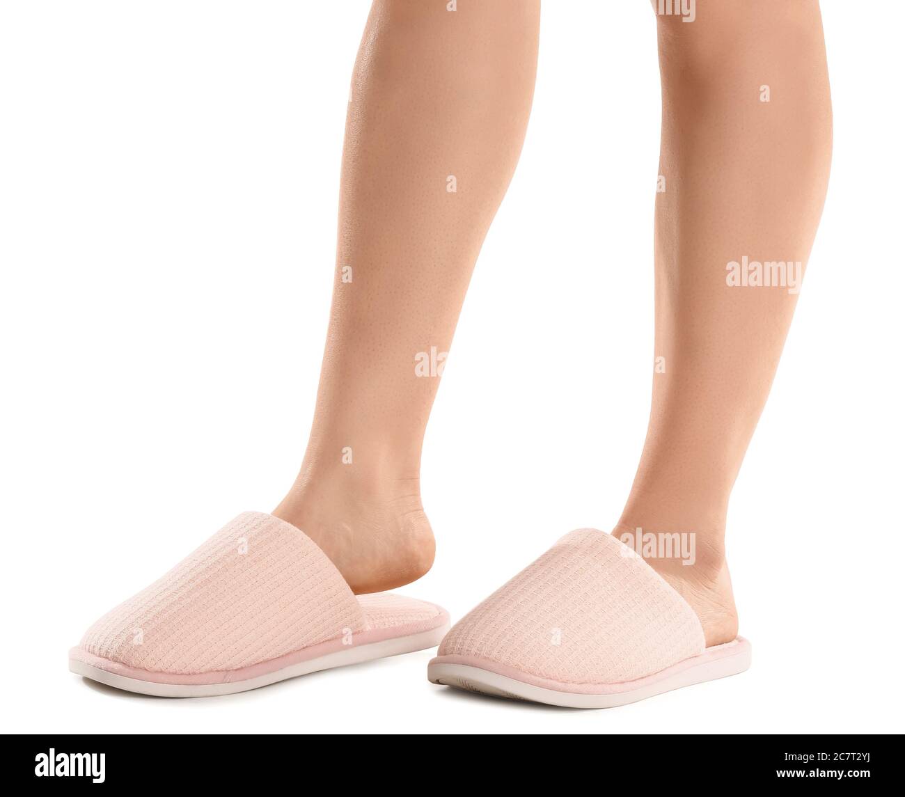 Female legs in soft slippers on white background Stock Photo - Alamy