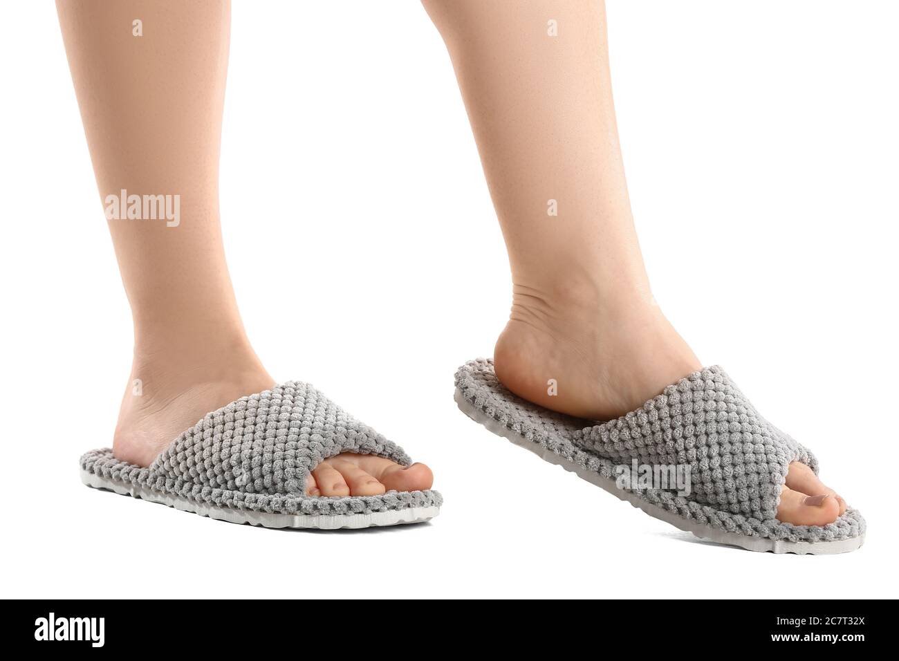 Female legs in soft slippers on white background Stock Photo - Alamy