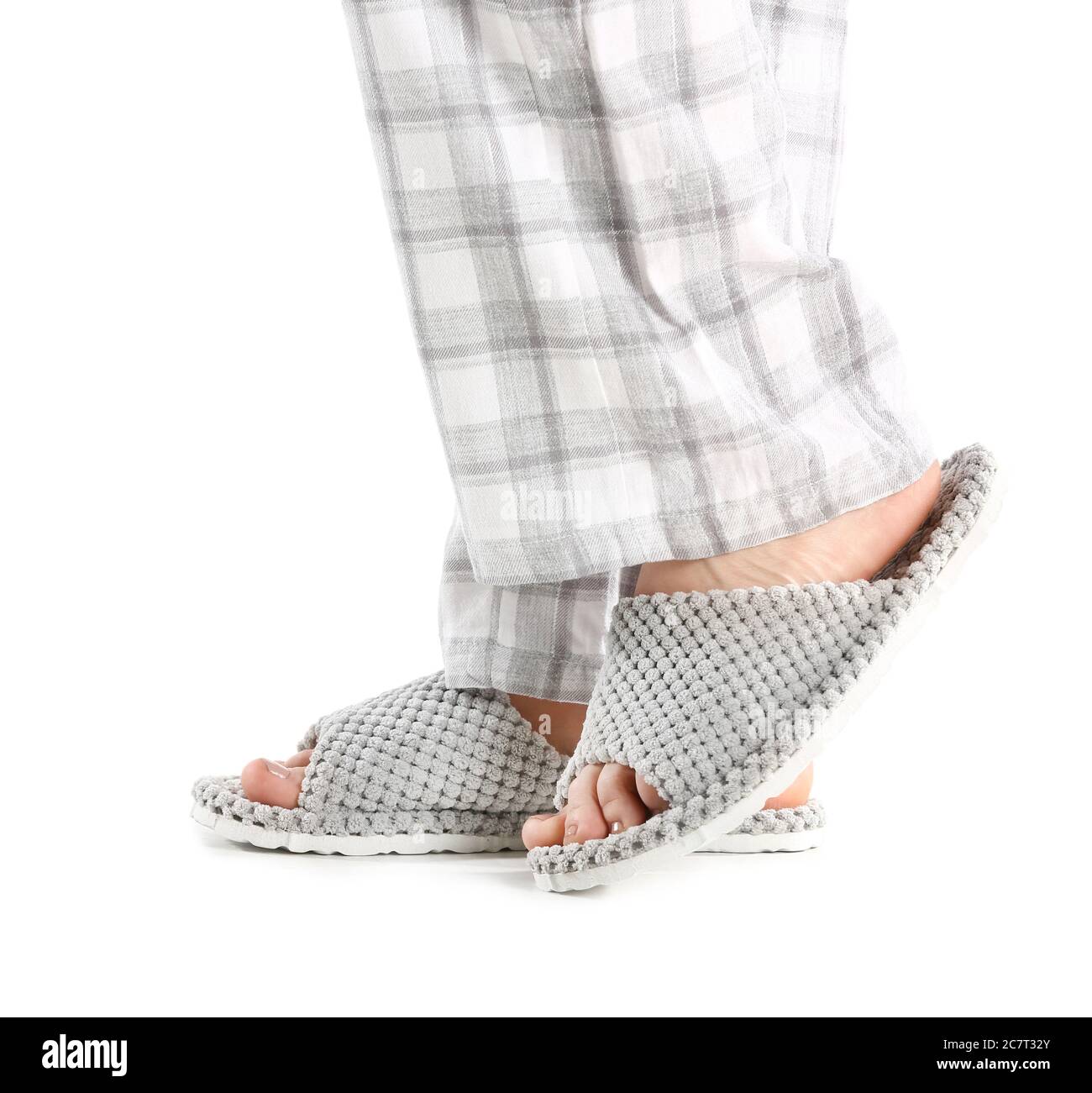 Female legs in soft slippers on white background Stock Photo - Alamy