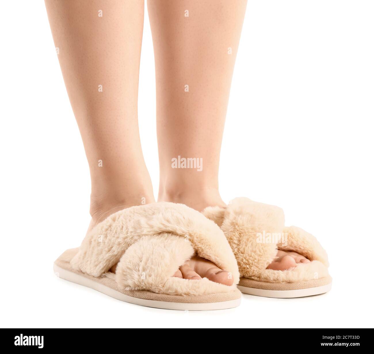 Female legs in soft slippers on white background Stock Photo - Alamy