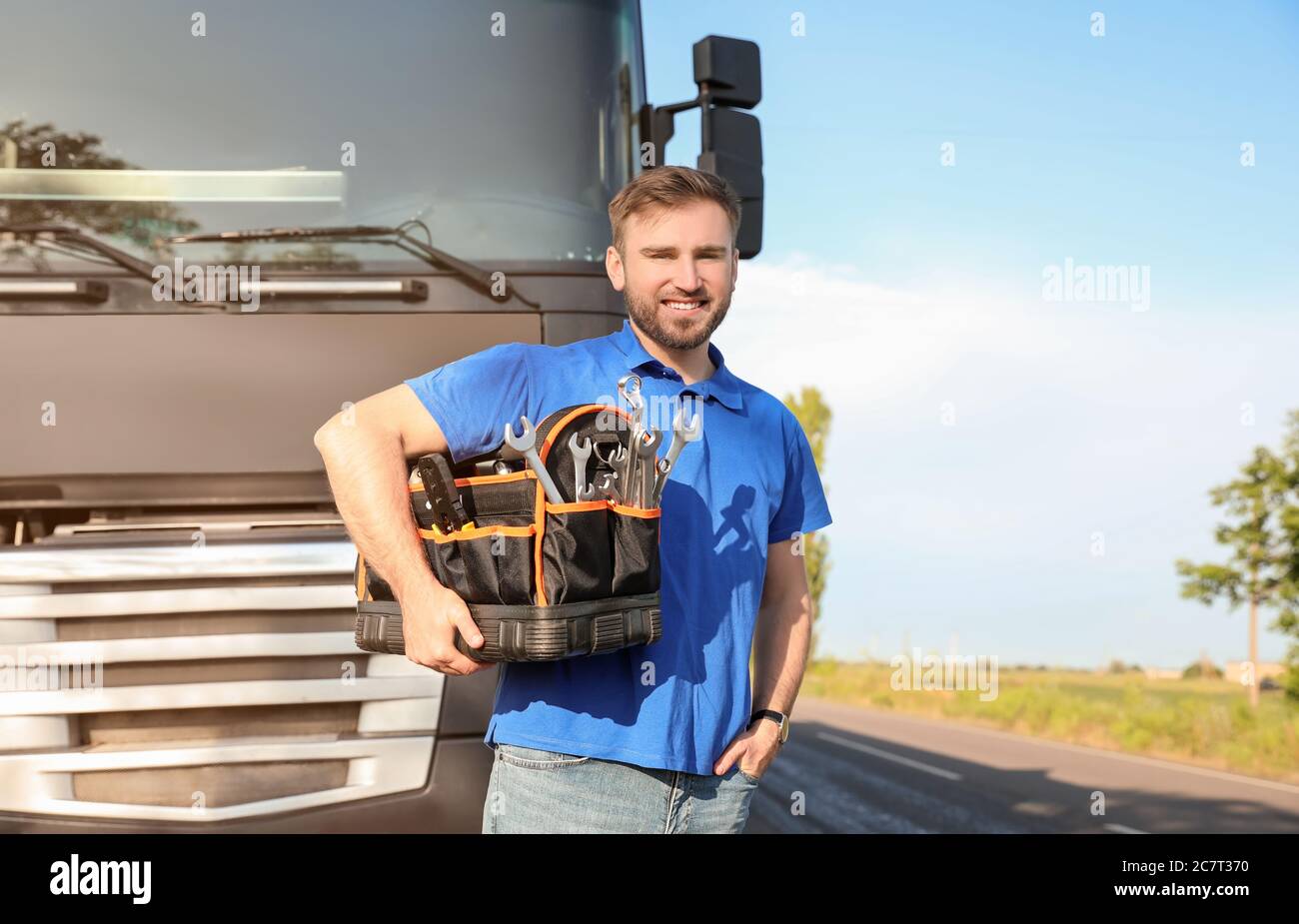 Male driver with tools near big truck outdoors Stock Photo - Alamy