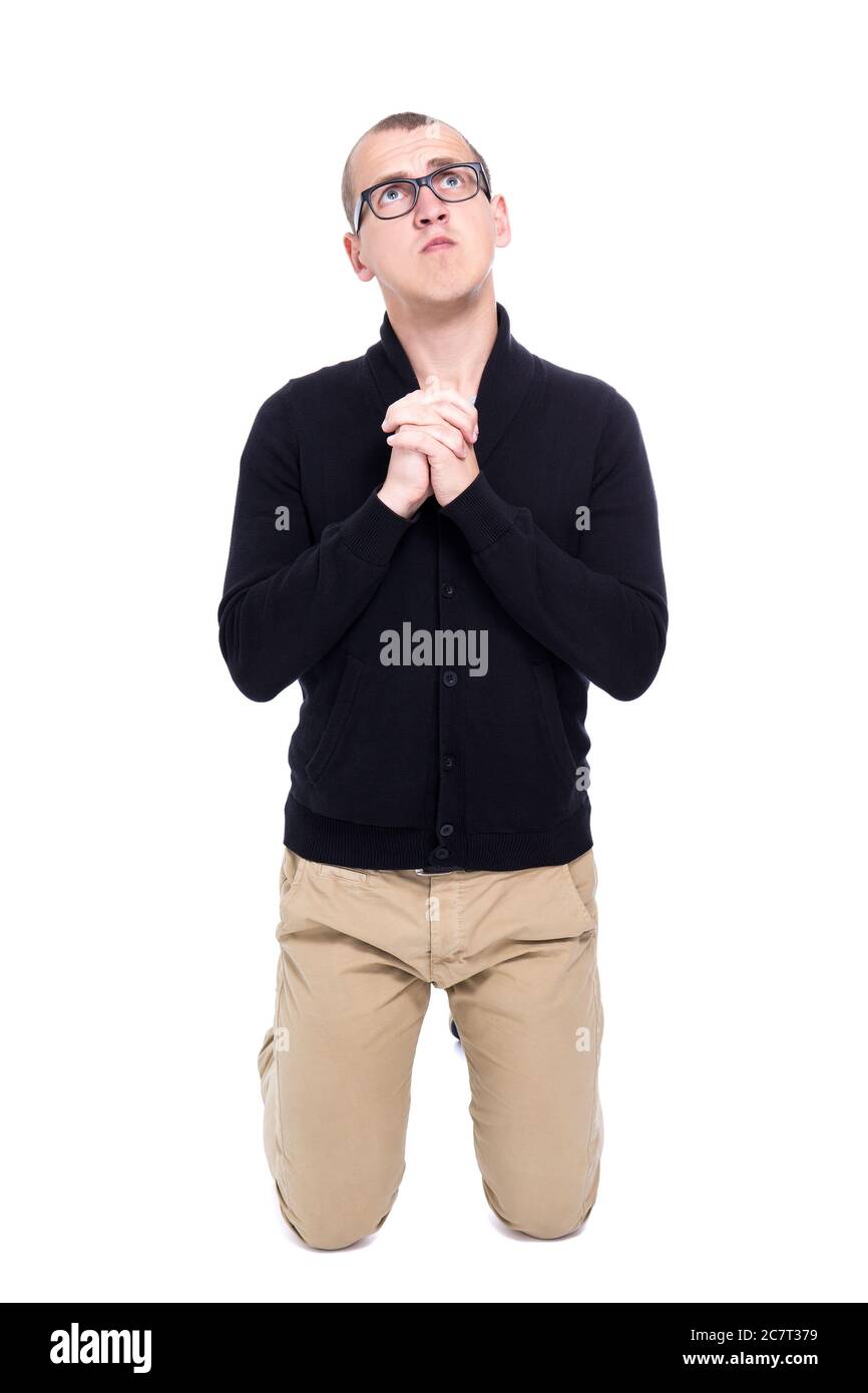 portrait of funny young man praying isolated on white background Stock ...
