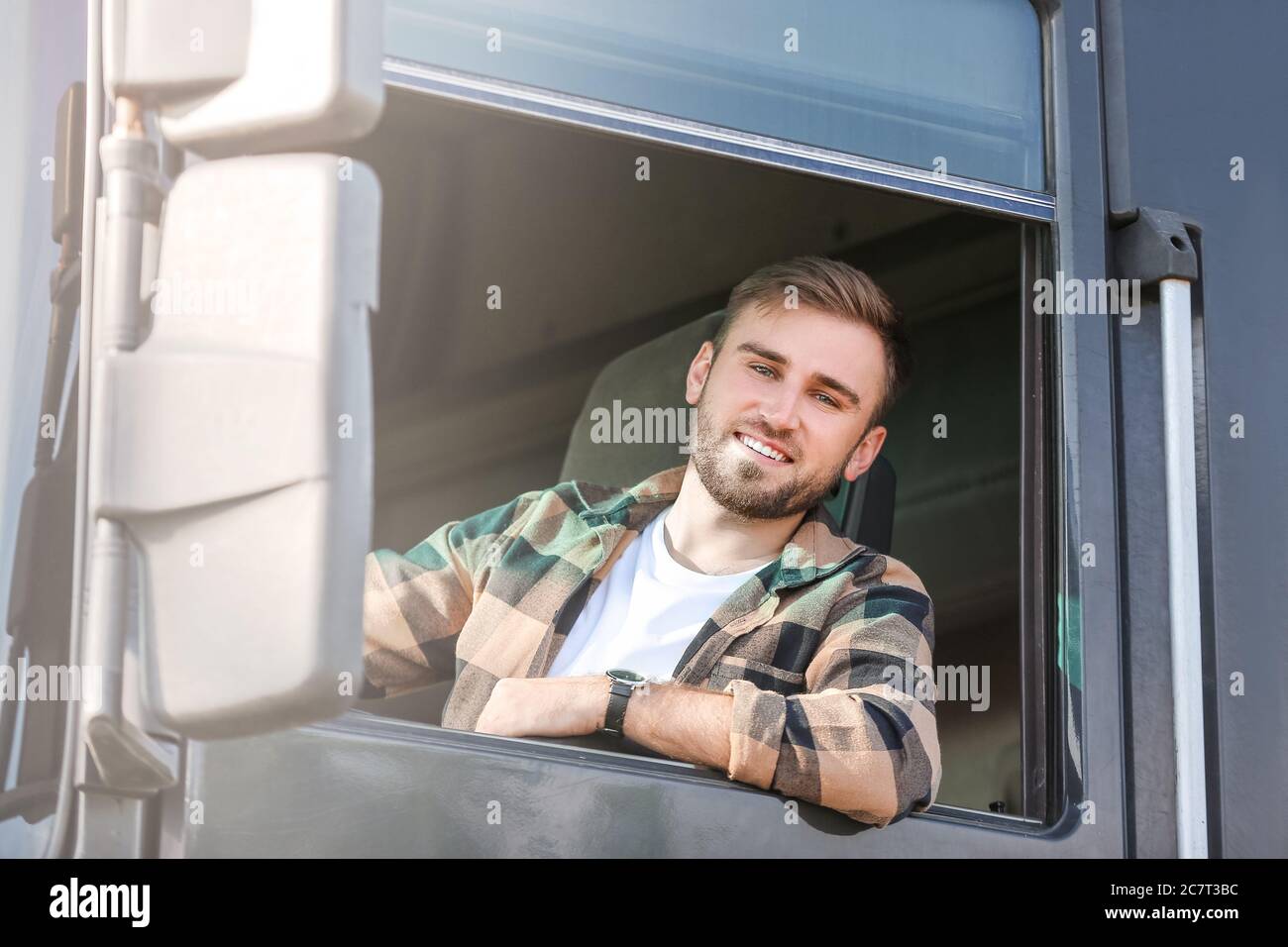 Young man driving modern truck Stock Photo - Alamy