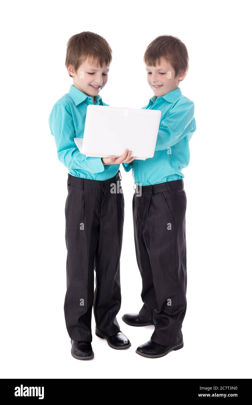 full length portrait of two little boys twins using laptop isolated on ...