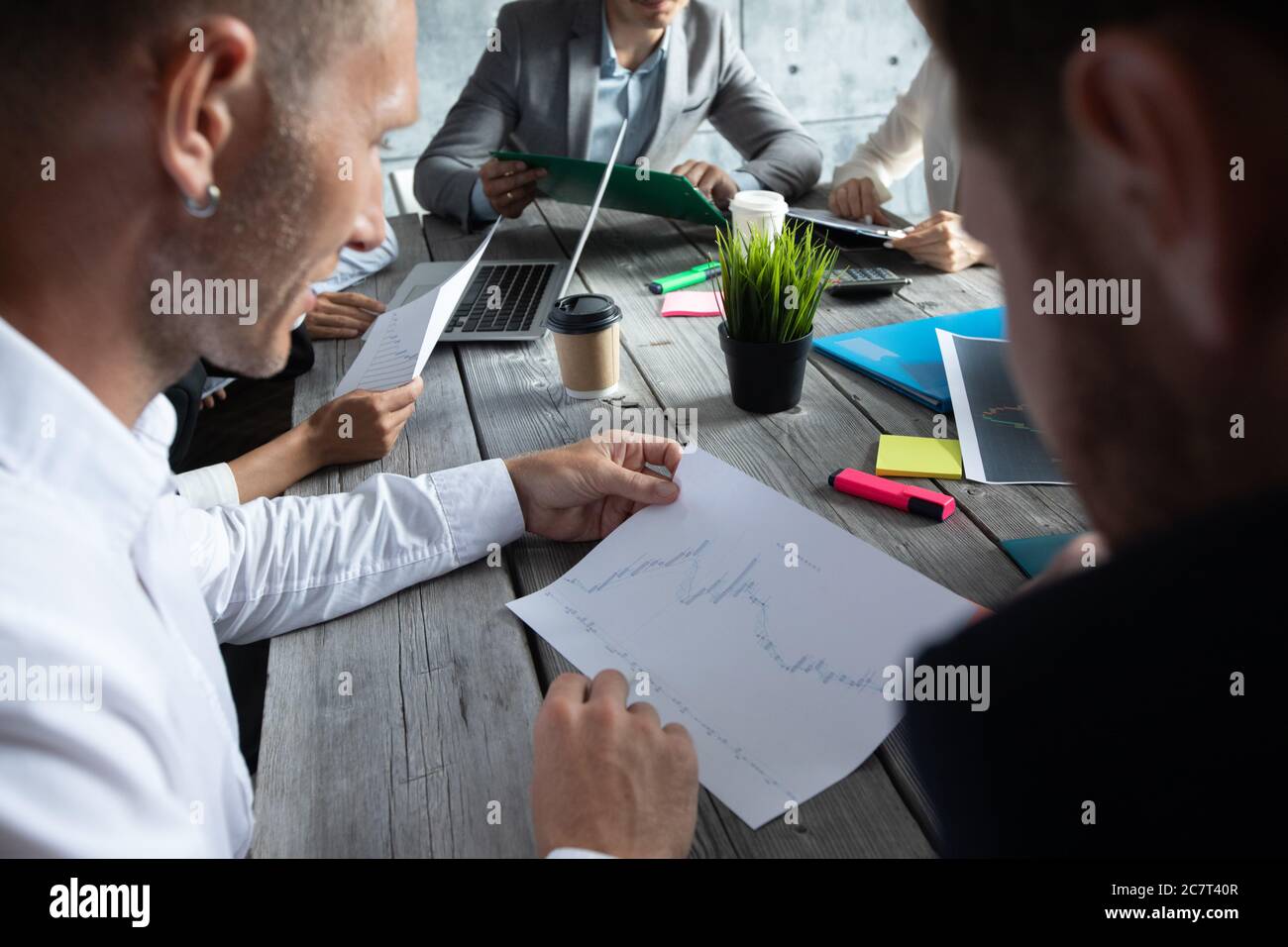 Business people analyzing data diagrams financial reports development ...