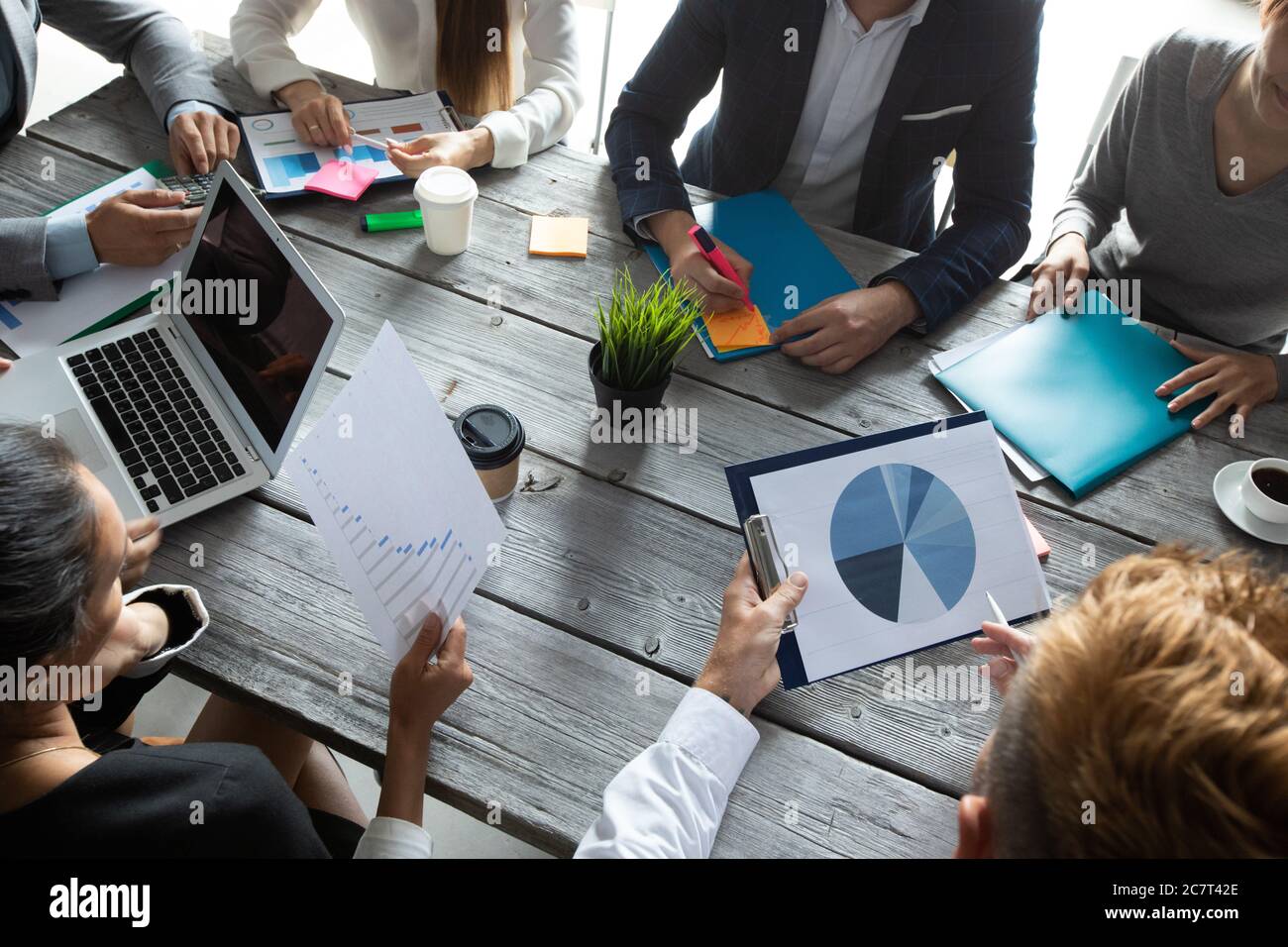 Business people analyzing data diagrams financial reports development ...