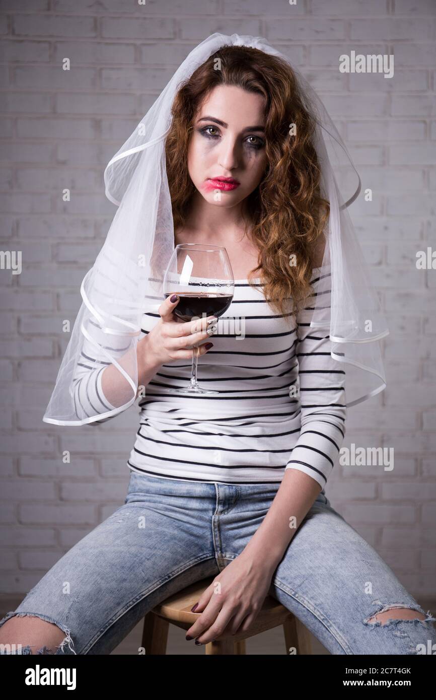 sad bride crying and drinking red wine Stock Photo - Alamy