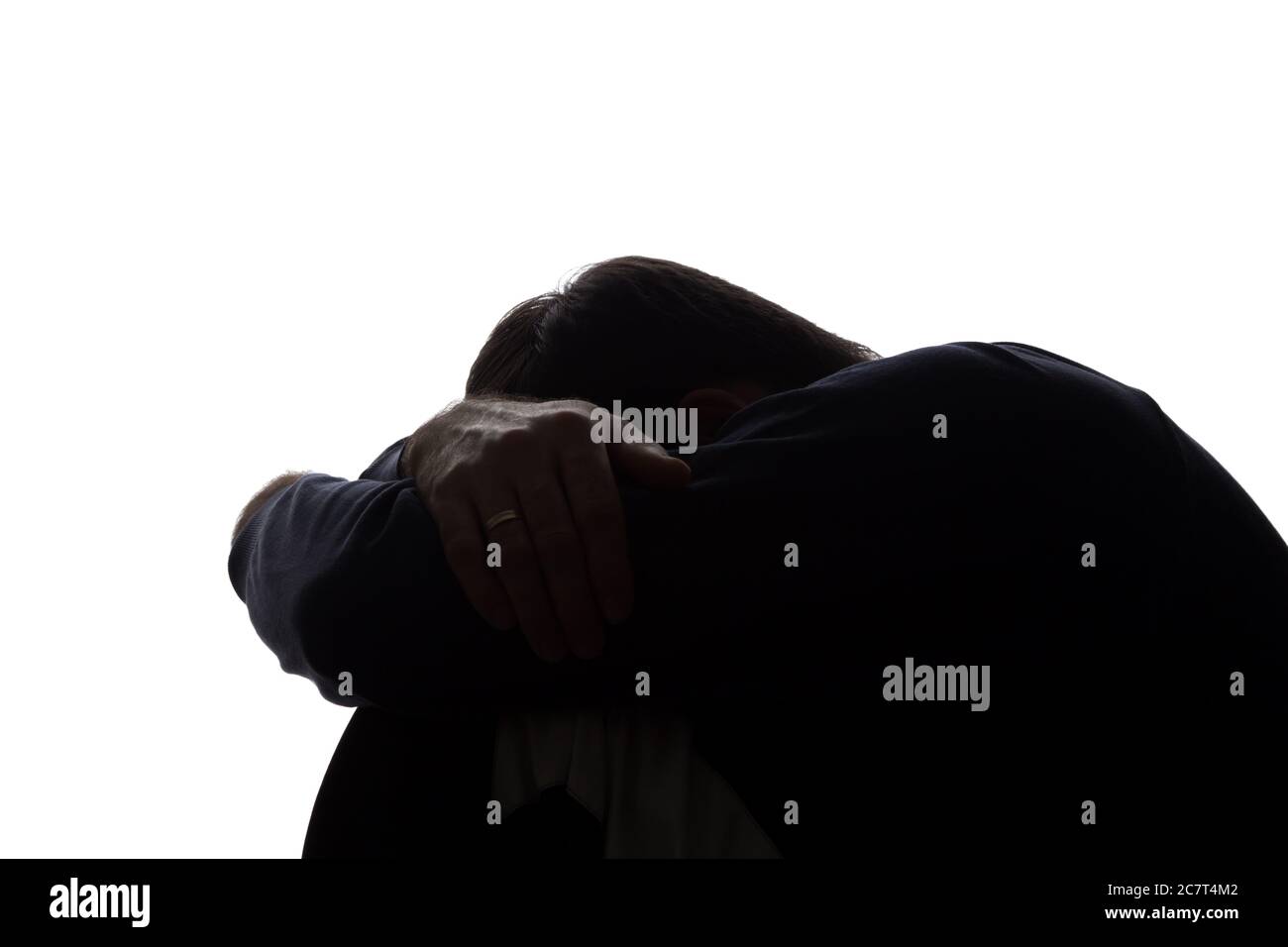 A young man with grief tearing at her hair - silhouette Stock Photo - Alamy