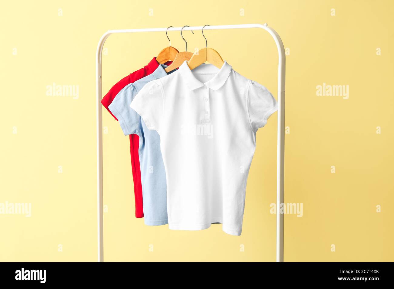 Rack with school uniform on color background Stock Photo - Alamy