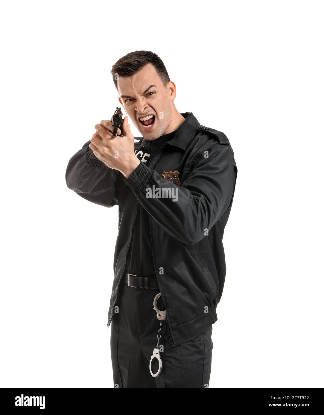 Aggressive police officer with gun on white background Stock Photo - Alamy