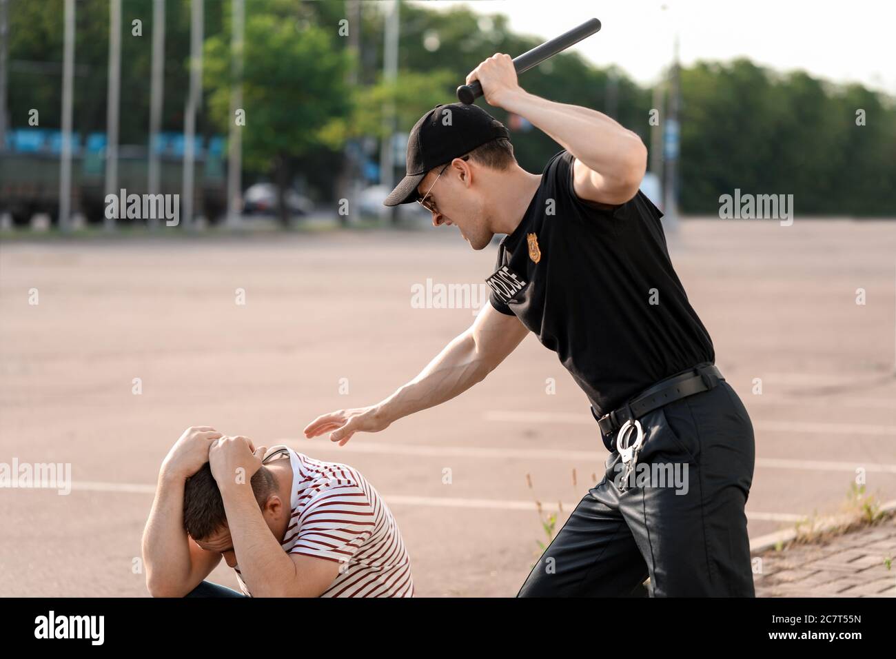 Aggressive police officer mistreating man outdoors Stock Photo - Alamy