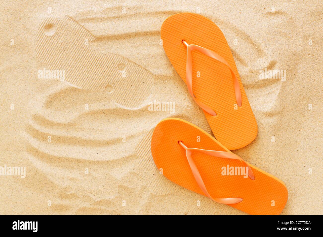 Stylish flip-flops on beach sand Stock Photo - Alamy